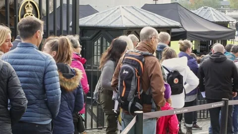 queuing up behind a crowd of people wait... | Stock Video | Pond5