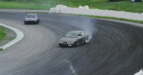 Race cars drifting on a track at a motor... | Stock Video | Pond5