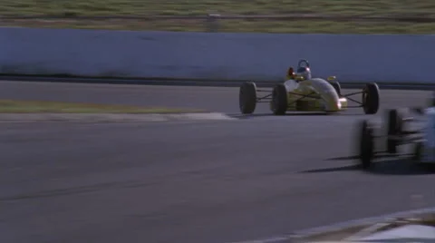 Race cars speed around a sharp turn on a... | Stock Video | Pond5