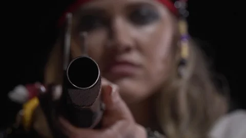 Rack focus on the pistol and a female pi... | Stock Video | Pond5