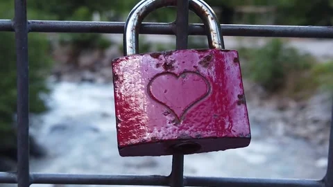 Rack focus of Red rusty love lock with h... | Stock Video | Pond5