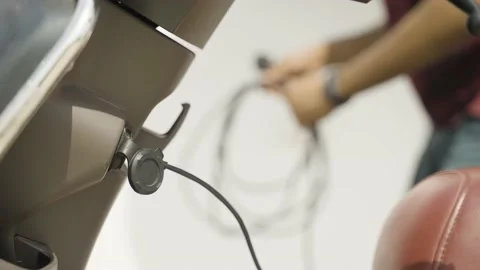 Rack focus shot of young man charging EV... | Stock Video | Pond5