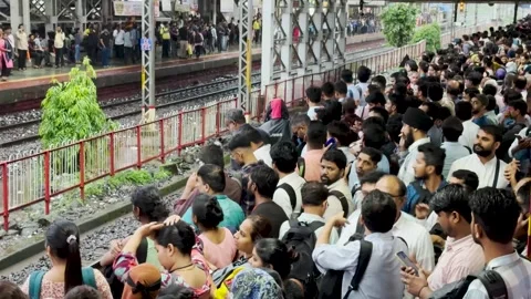 Railway platform packed with people wait... | Stock Video | Pond5