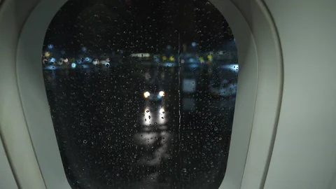 Rain and drops on jet plane window at ai... | Stock Video | Pond5