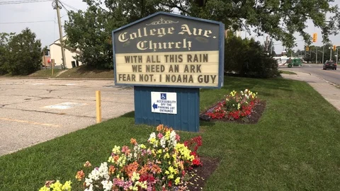Rain and flooding leads to funny sign at... | Stock Video | Pond5