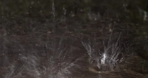 Rain drops bouncing off of concrete side... | Stock Video | Pond5