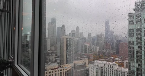 Rain falling down window in city | Stock Video | Pond5