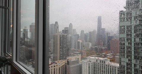 Rain falling down window in large city | Stock Video | Pond5