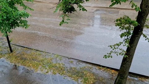 Rain falling onto pavement and road with... | Stock Video | Pond5