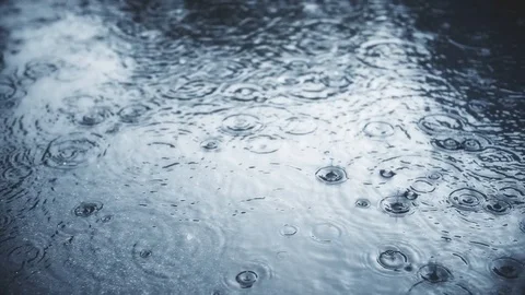 Rain falling on pavement in slow motion. | Stock Video | Pond5
