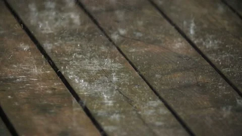 Rain falling on wooden deck. Shallow dep... | Stock Video | Pond5
