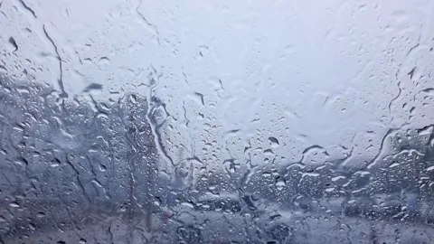 Rain hitting car window on blurred natur... | Stock Video | Pond5