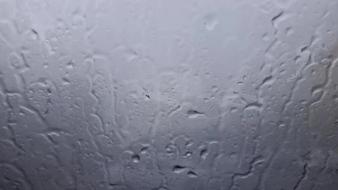 Rain hitting car window on blurred natur... | Stock Video | Pond5