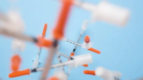 Rain of plastic insulin syringes falling... | Stock Video | Pond5