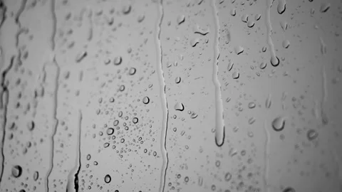 Raindrops dripping on a window glass. He... | Stock Video | Pond5
