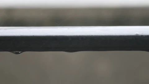 Raindrops falling down of a balcony rail... | Stock Video | Pond5
