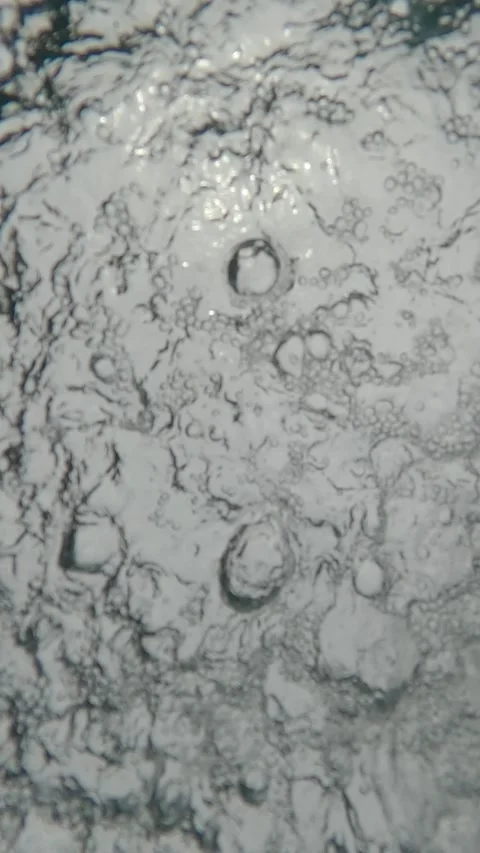 Raindrops falling on water surface, Bott... | Stock Video | Pond5