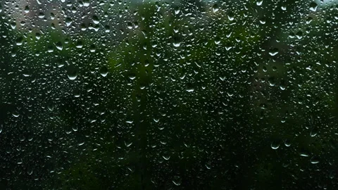 Raindrops on glass on a dark background.... | Stock Video | Pond5