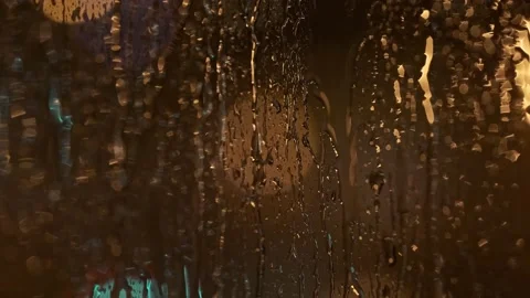 Raindrops run down the window glass with... | Stock Video | Pond5