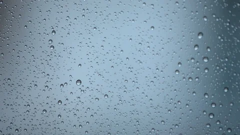 Raindrops sliding down the glass window ... | Stock Video | Pond5