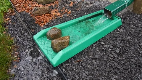 Rainwater, green drain pipe, gravel,trou... | Stock Video | Pond5