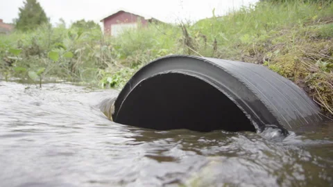 Rainwater runoff flows into big black dr... | Stock Video | Pond5