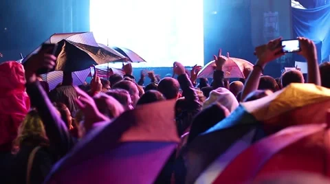 Rainy Concert People raise their hands a... | Stock Video | Pond5
