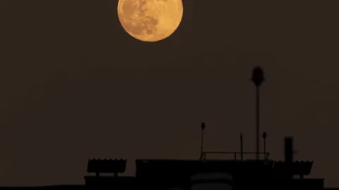 Raising moon on dark night sky | Stock Video | Pond5