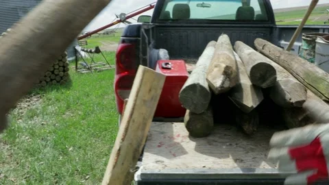 Ranchers loading fence posts onto pickup... | Stock Video | Pond5