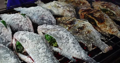 Raw tilapia fish skewer grilled on a hot... | Stock Video | Pond5