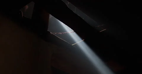 Ray of sunlight through crack in roof of... | Stock Video | Pond5