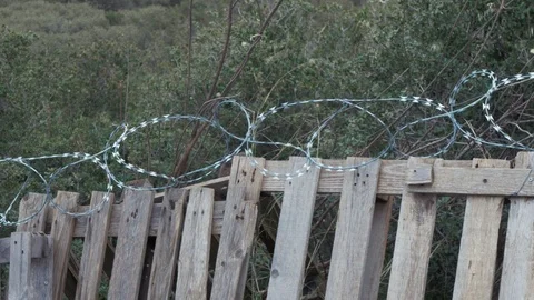 Razor wire barged wire on pallet fence | Stock Video | Pond5