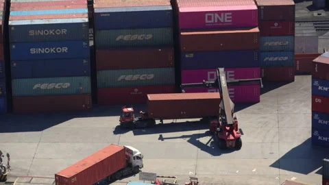 Reachstacker loads containers onto a tru... | Stock Video | Pond5