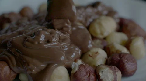 Real Liquid Chocolate Covers Hazelnuts i... | Stock Video | Pond5
