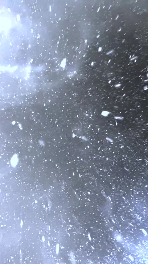 Real snow falls on camera. Falling snow.... | Stock Video | Pond5