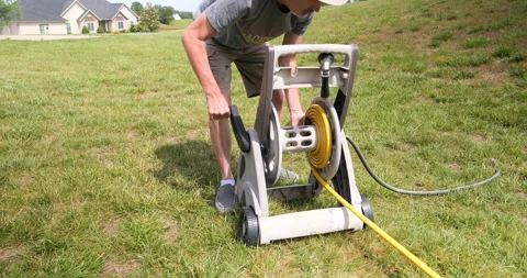 Real time winding up water hose on reel | Stock Video | Pond5