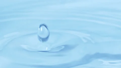 Real of water drop falls into water and ... | Stock Video | Pond5