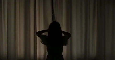 Rear back view young woman opening curta... | Stock Video | Pond5