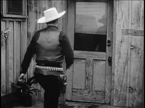 Rear view of cowboy kicking in wooden do... | Stock Video | Pond5