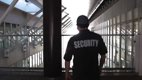 Rear view of security guard in uniform p... | Stock Video | Pond5