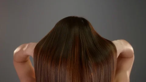 Rear view of woman with hand in hair | Stock Video | Pond5