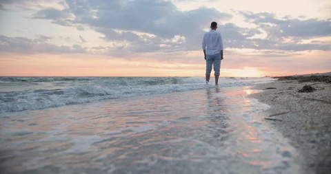 Rear view of a young man standing by the... | Stock Video | Pond5