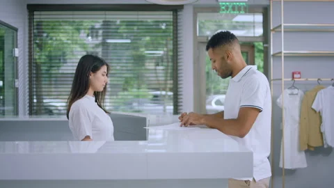 At reception desk beautiful medical assi... | Stock Video | Pond5