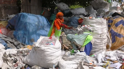 Recyclable waste pickers work on garbage... | Stock Video | Pond5