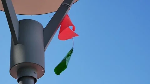 Red and green plastic flags tied to ligh... | Stock Video | Pond5
