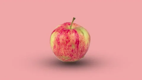 red apple rotating pink background | Stock Video | Pond5