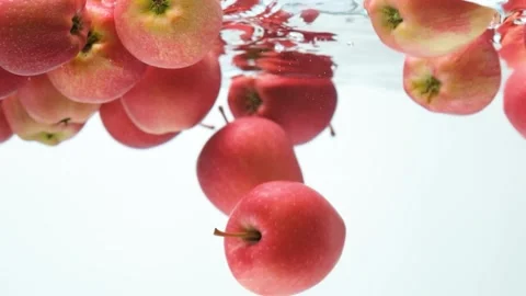 Red Apples Floating in Clear Water. Slow... | Stock Video | Pond5