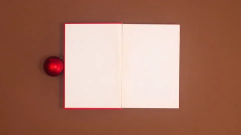 Red book open and Christmas ornaments ap... | Stock Video | Pond5