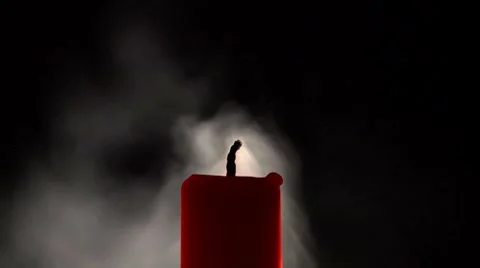 A red candle flame gutters in the wind, ... | Stock Video | Pond5