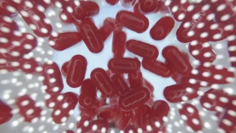 Red capsules of the medication is fallin... | Stock Video | Pond5